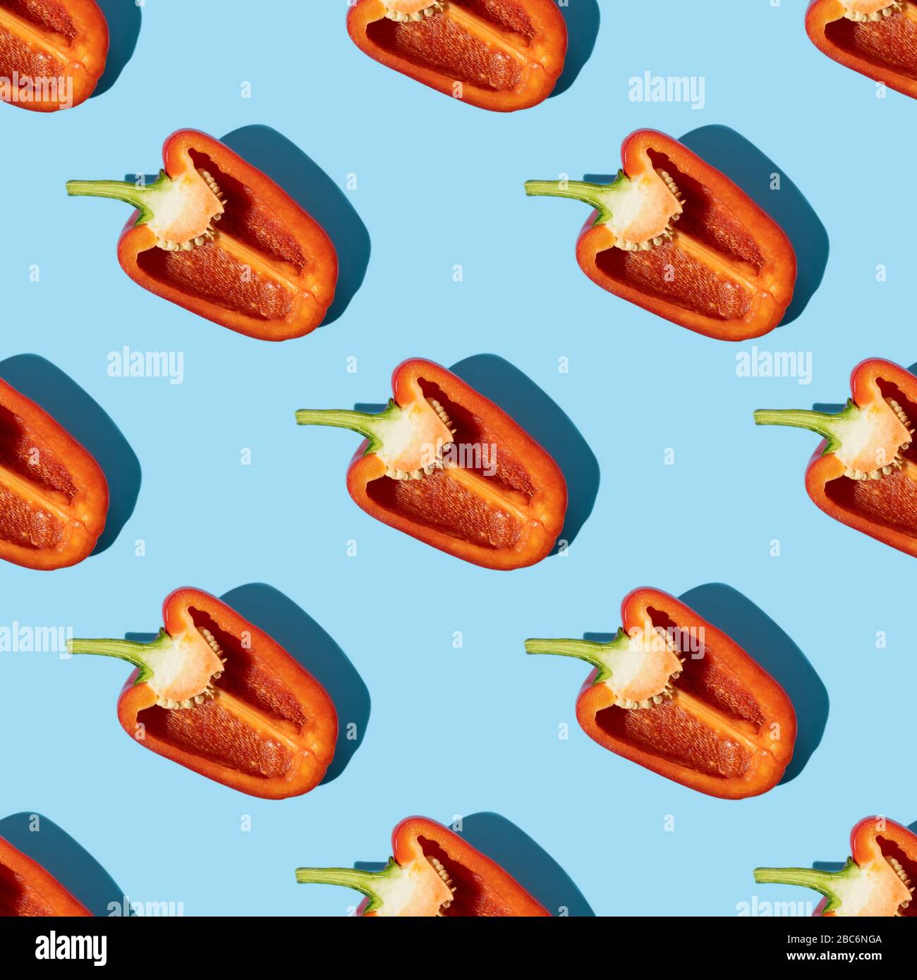 Seamless pattern of half red pepper with shadow on blue color ...