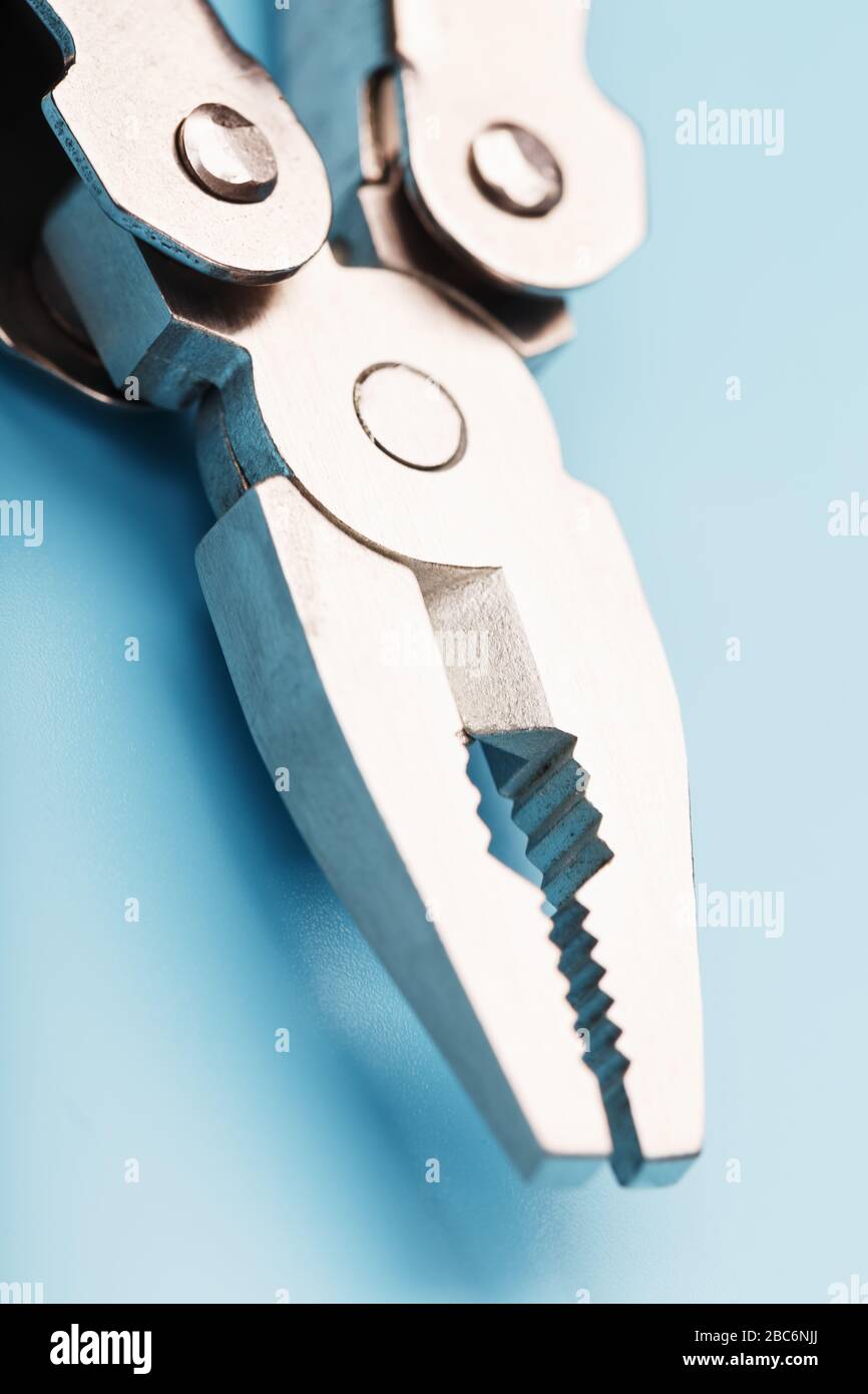The multitool multi-function tool hovers on a blue background. The ...