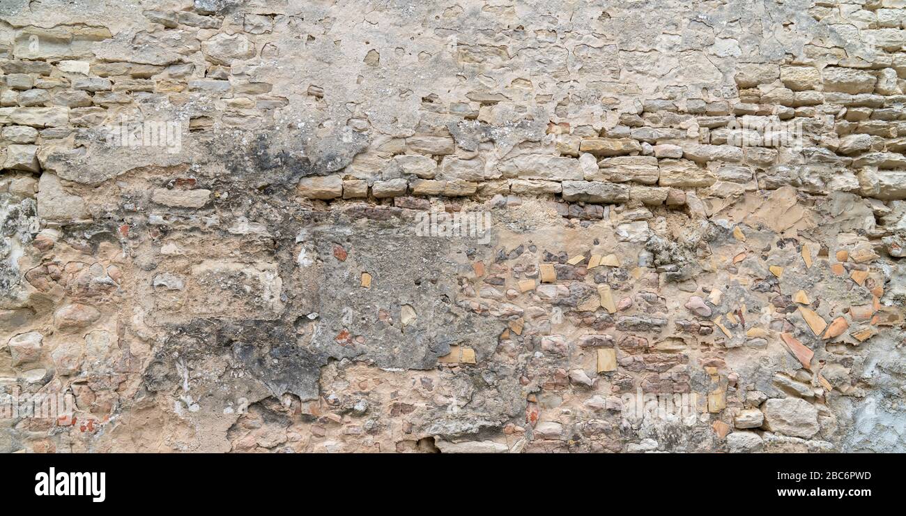 Old stone damaged wall fragment with scratches and cracks texture ...