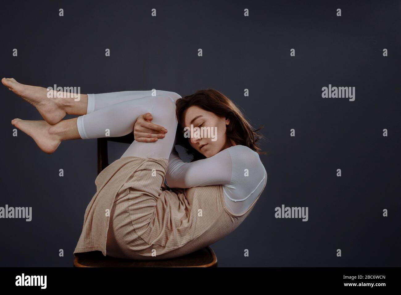 Curled up in chair hi-res stock photography and images - Alamy