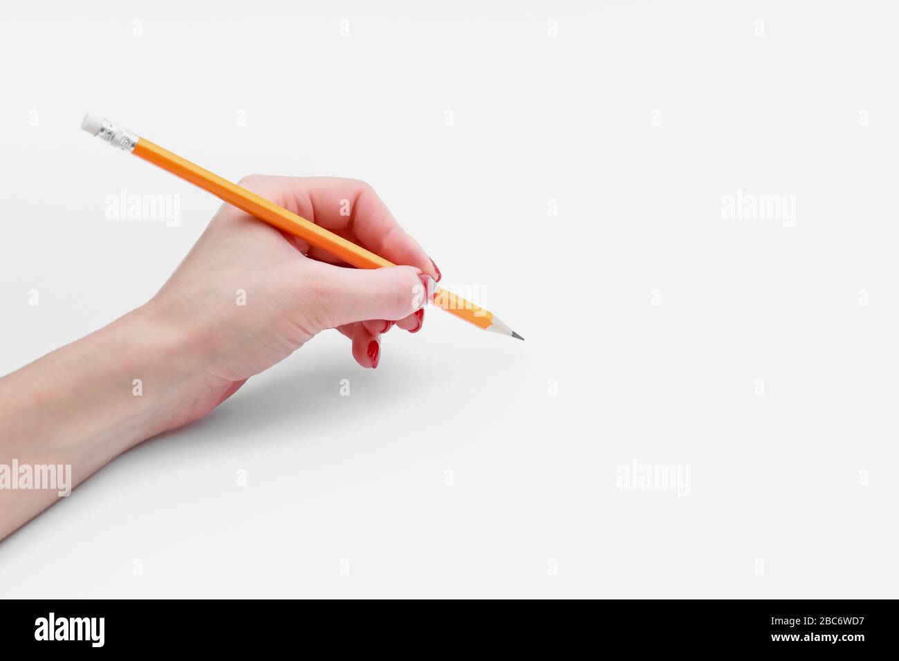 Female hand holding pencil isolated on white background, close-up ...