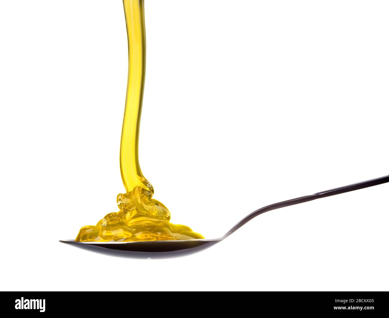 Falling and flowing honey on a spoon isolated on white background with ...