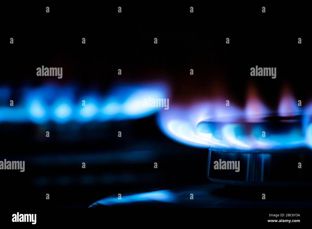 Burner gas stove close-up. Gas burns with a blue flame Stock Photo - Alamy