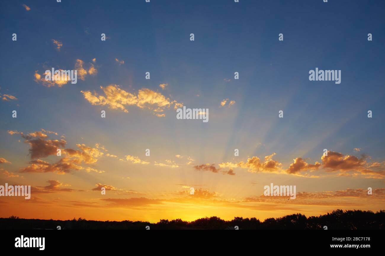 Sunset sunrise with clouds, light rays and other atmospheric effect ...
