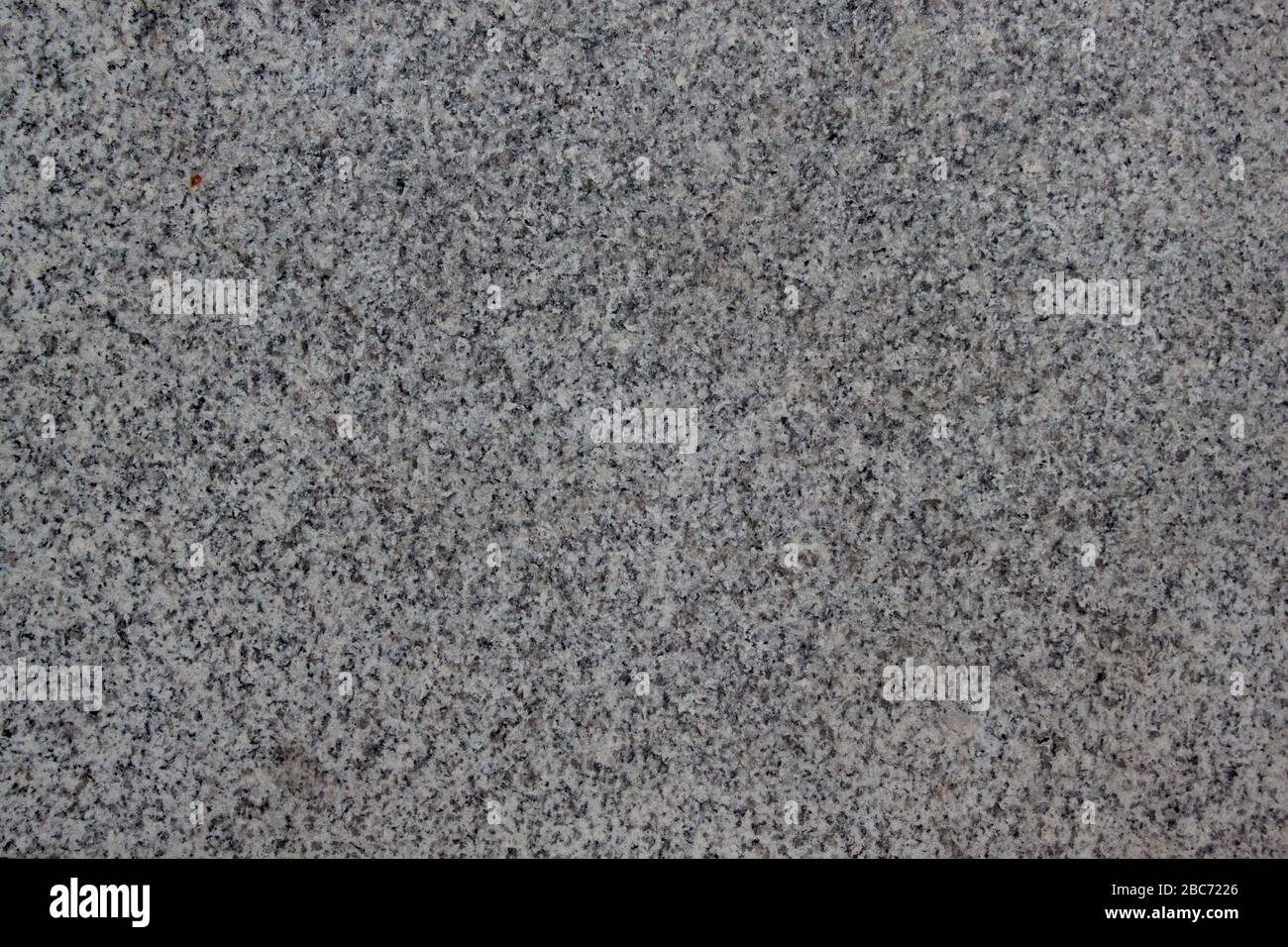 Gray grainy texture with marble chips. Used as a background. Copy space ...