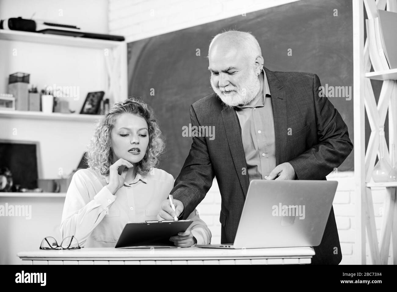 Pass exam. Man mature school teacher and girl with laptop. Final test ...