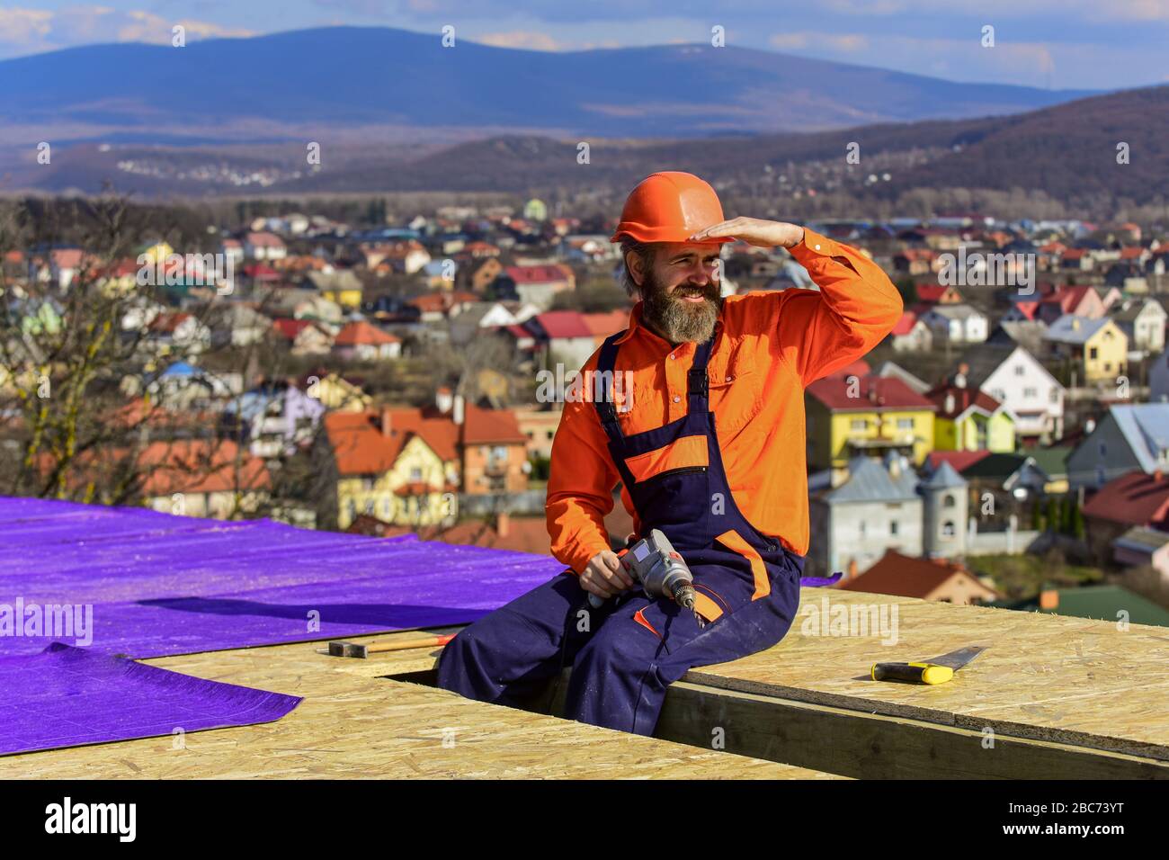 Roofer constructing roof. Master repair roof. Flat roof installation ...