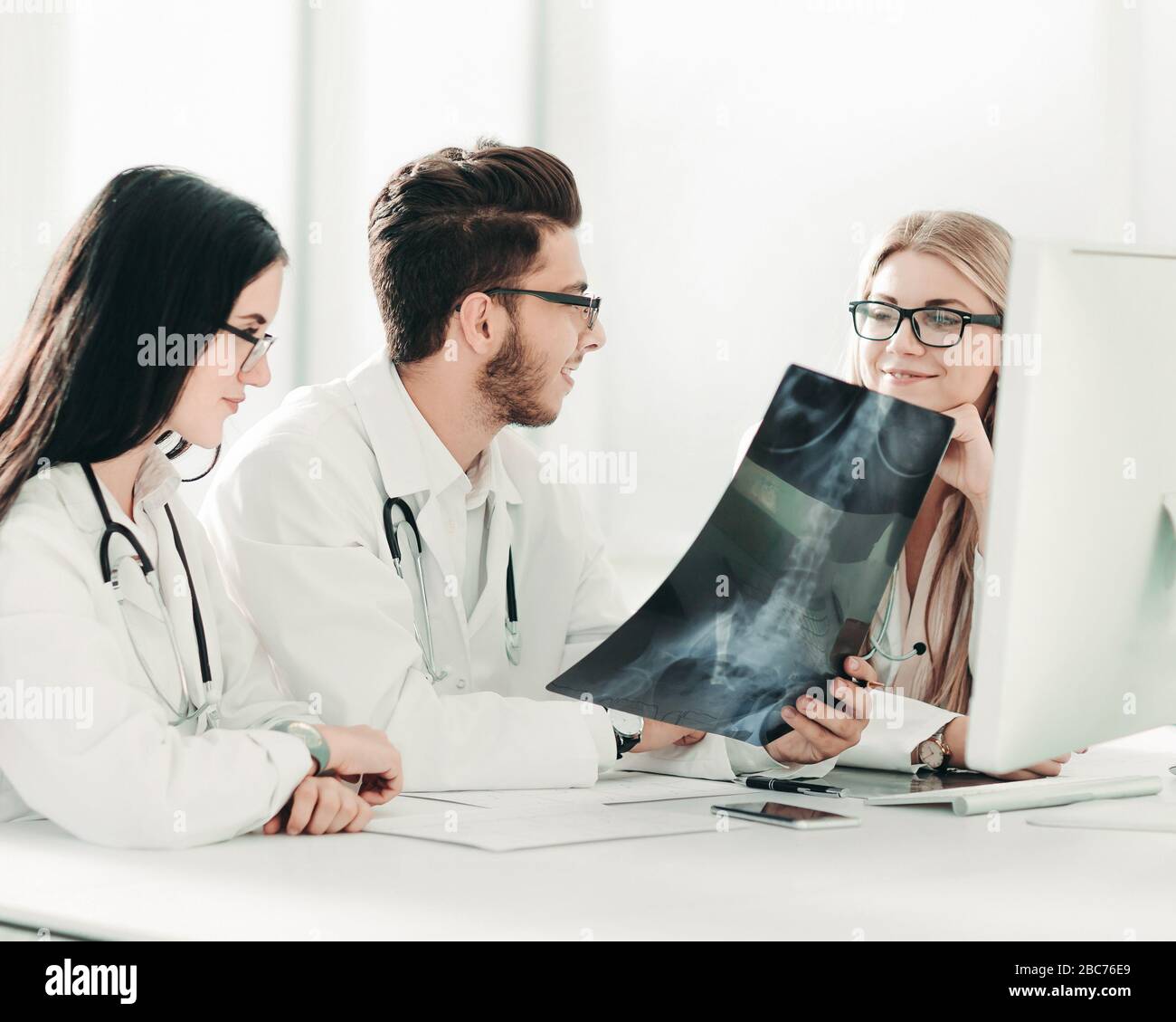 doctors experts discuss x-ray,sitting at the table .photo with copy ...