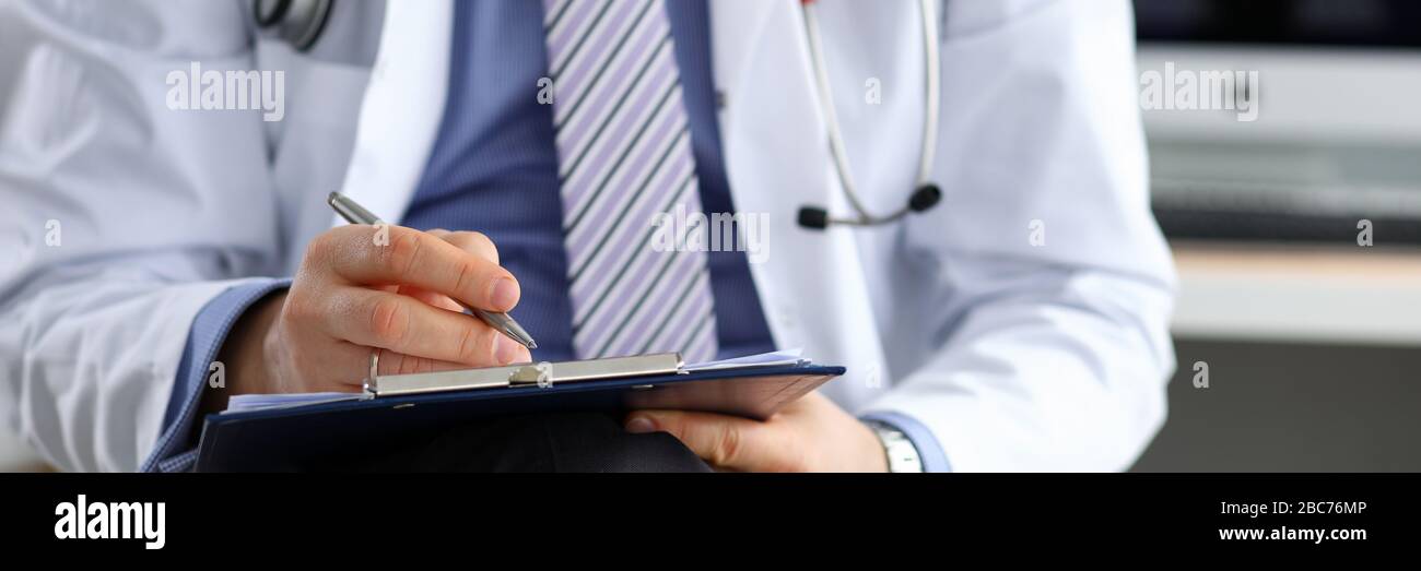 Male medicine doctor hand holding silver pen writing Stock Photo - Alamy
