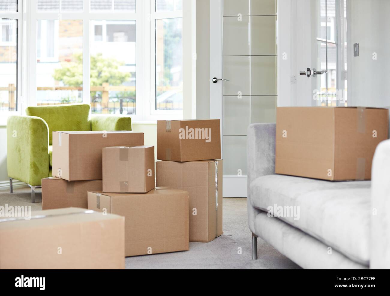 Cardboard carton boxes stack with household belongings in modern house ...