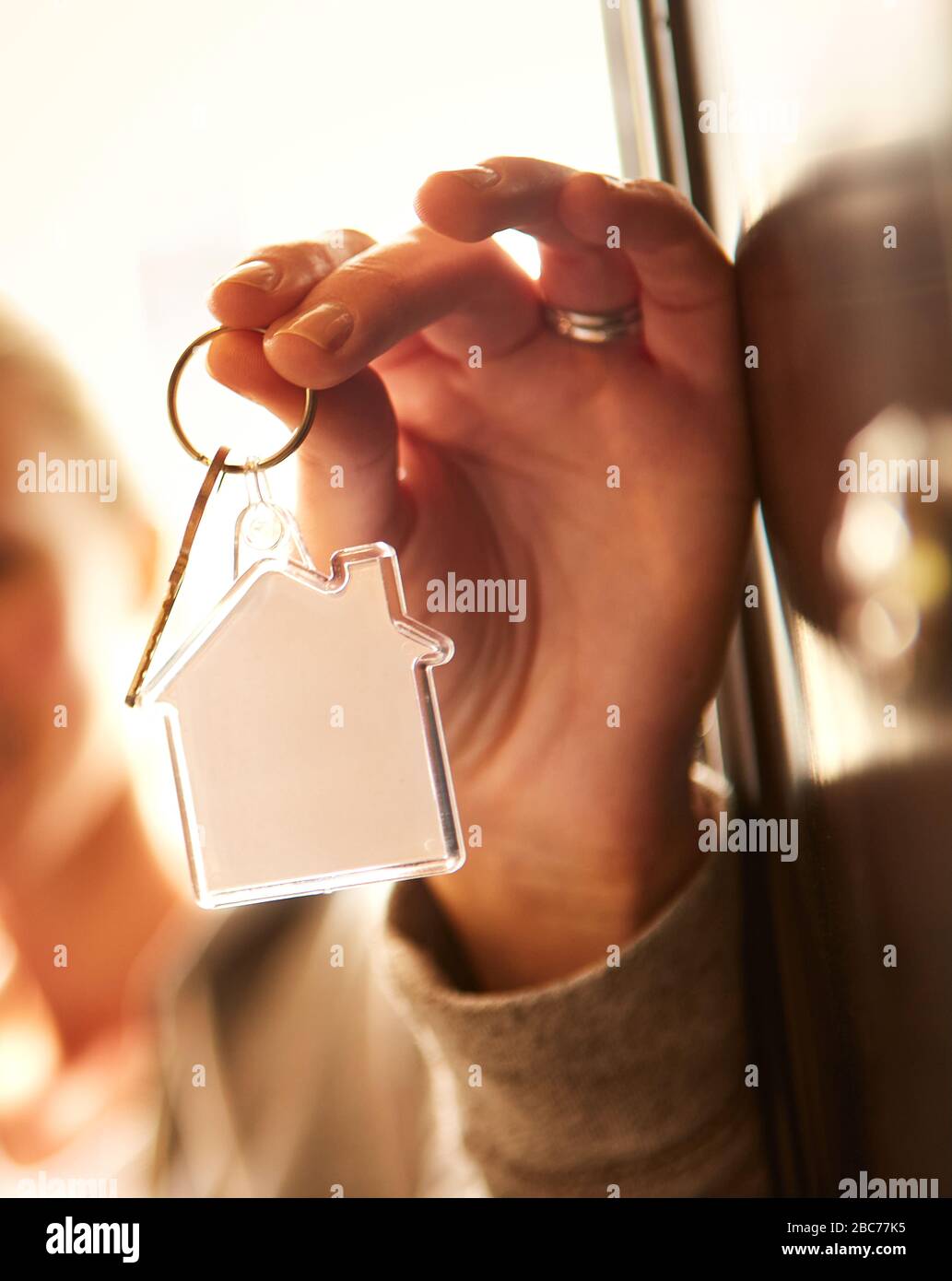 Closeup of a person hand holding the key to a new house Stock Photo - Alamy