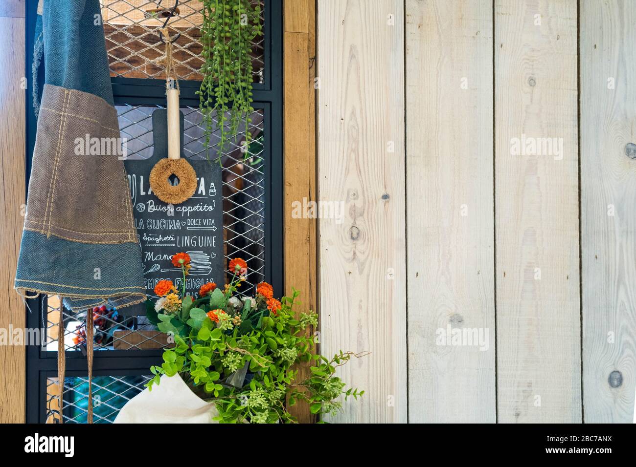 Plant inside a tote bag and apron kitchen decoration hanging on a steel ...