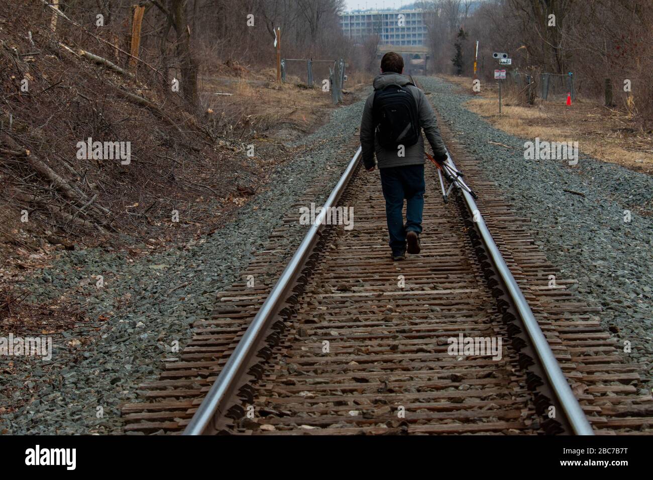 A man walking on the tracks Stock Photo - Alamy