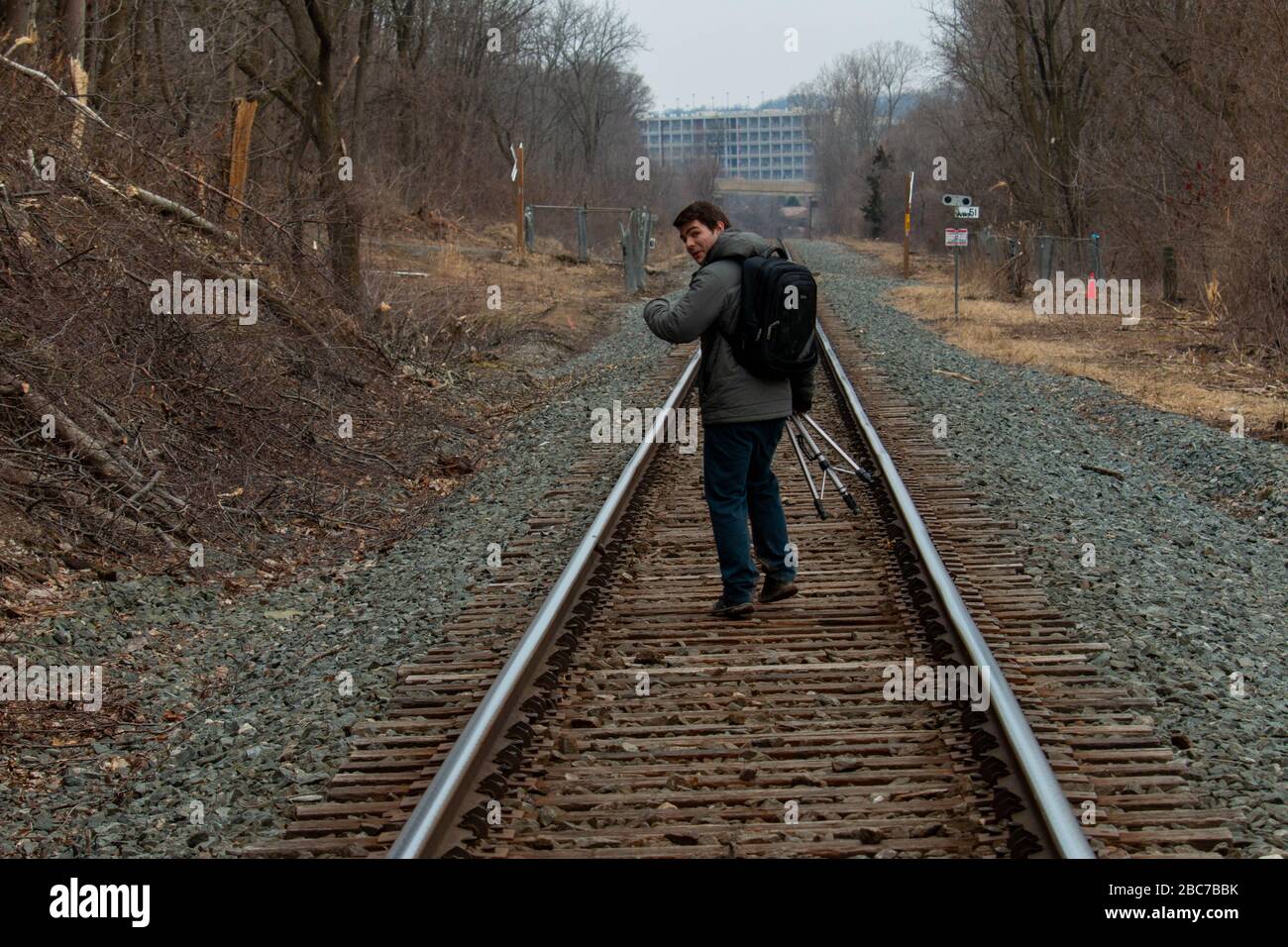 A man walking on the tracks Stock Photo - Alamy