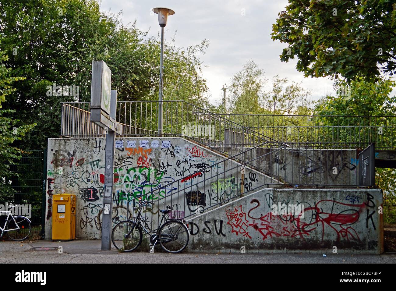 Photography of various graffiti on a concrete staircase surrounded by ...