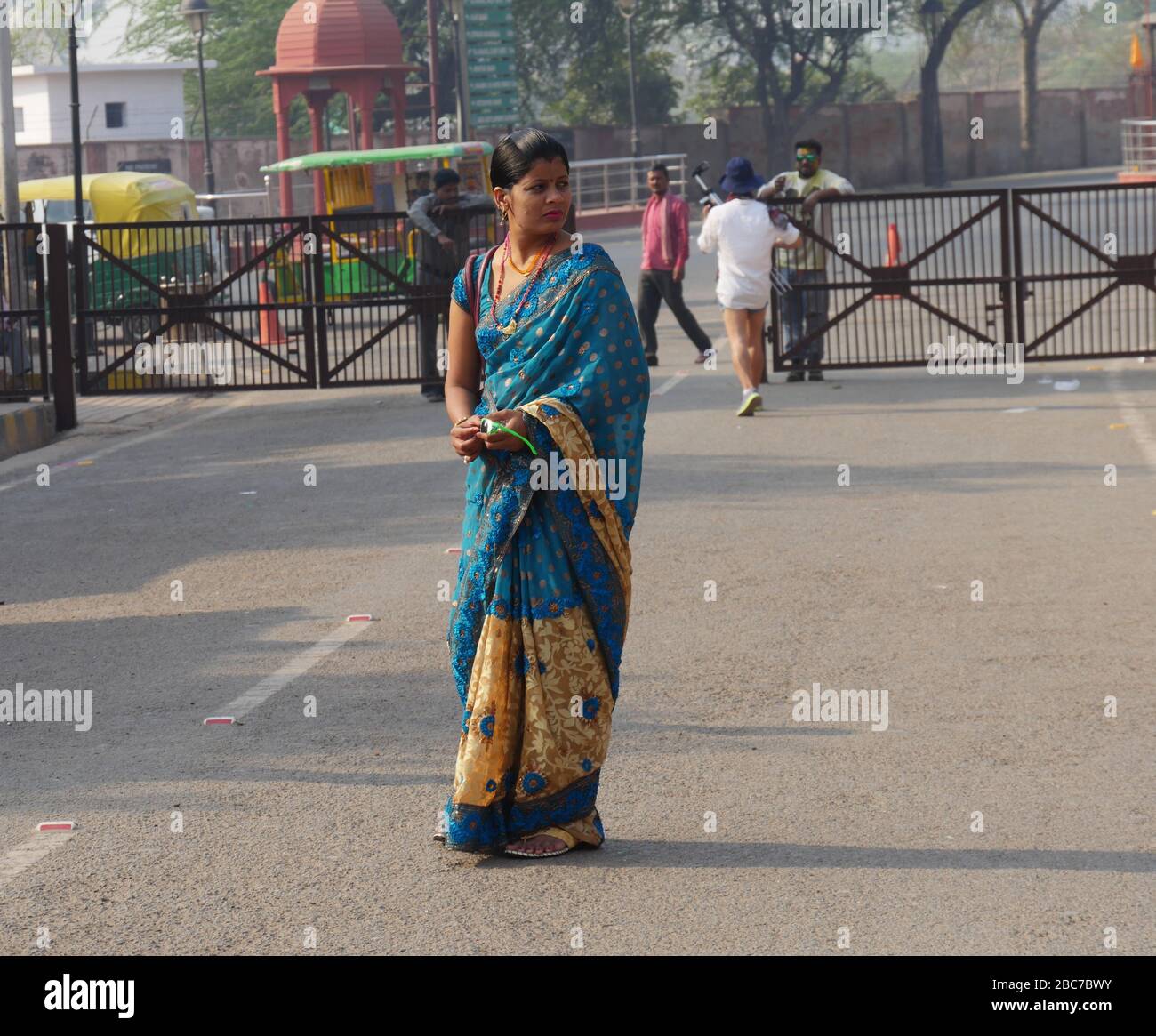 Agra, Uttar Pradesh, India- March 2018: A woman stands near the gates ...
