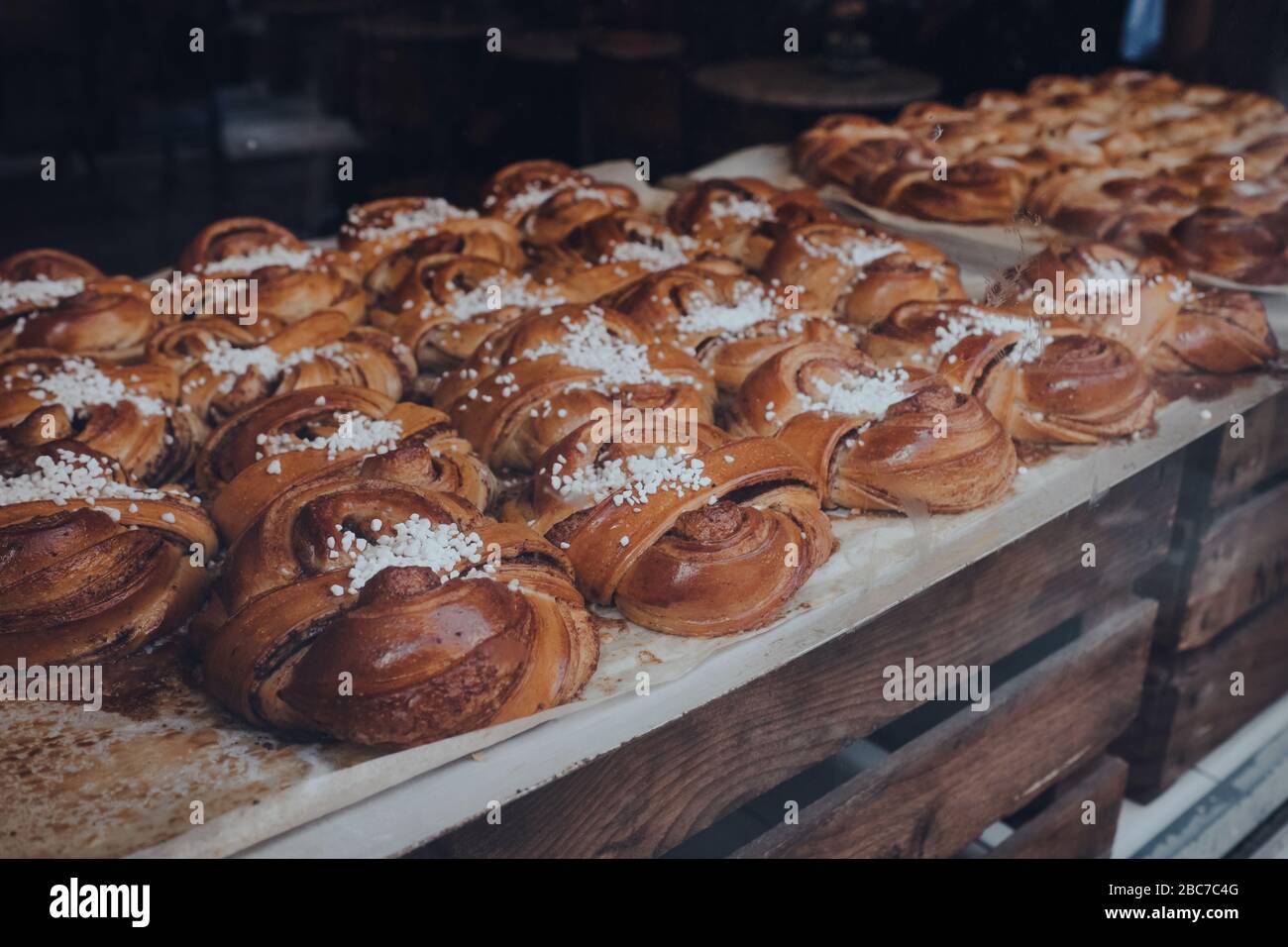 Rows of fresh Danish pastries on a window display of a bakery ...