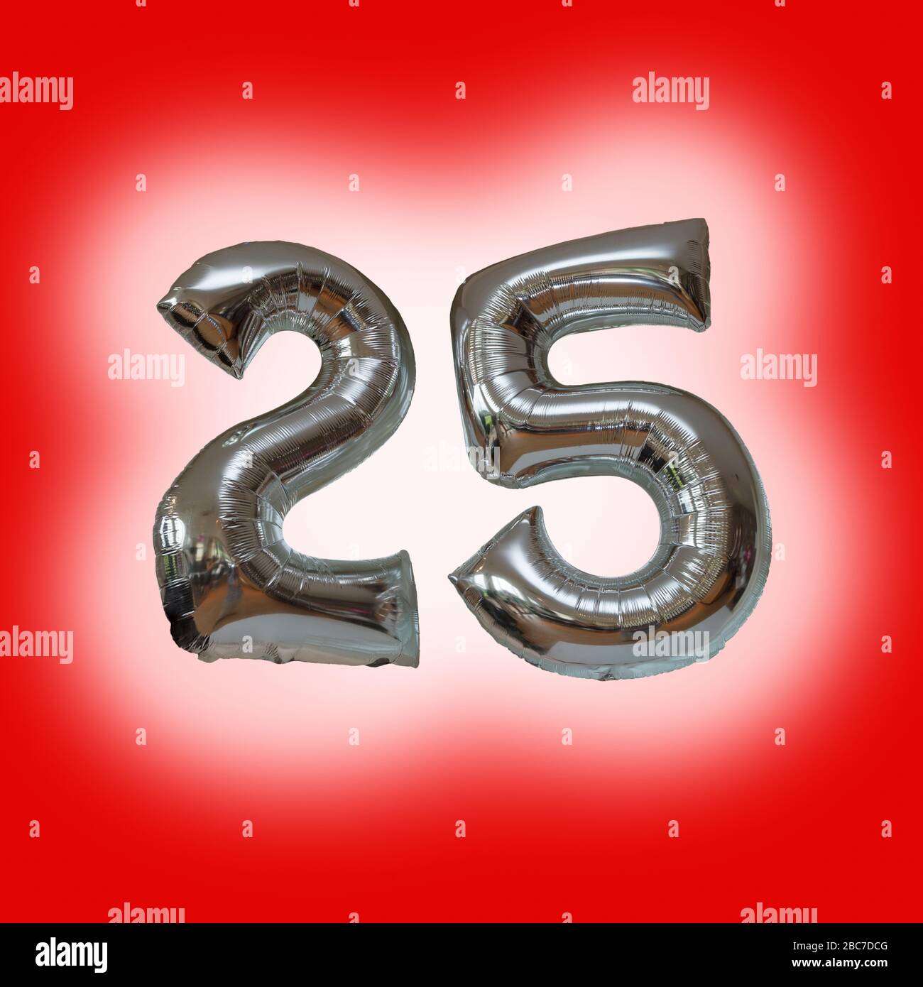Silver number 25 party balloons isolated on a blue background with a ...