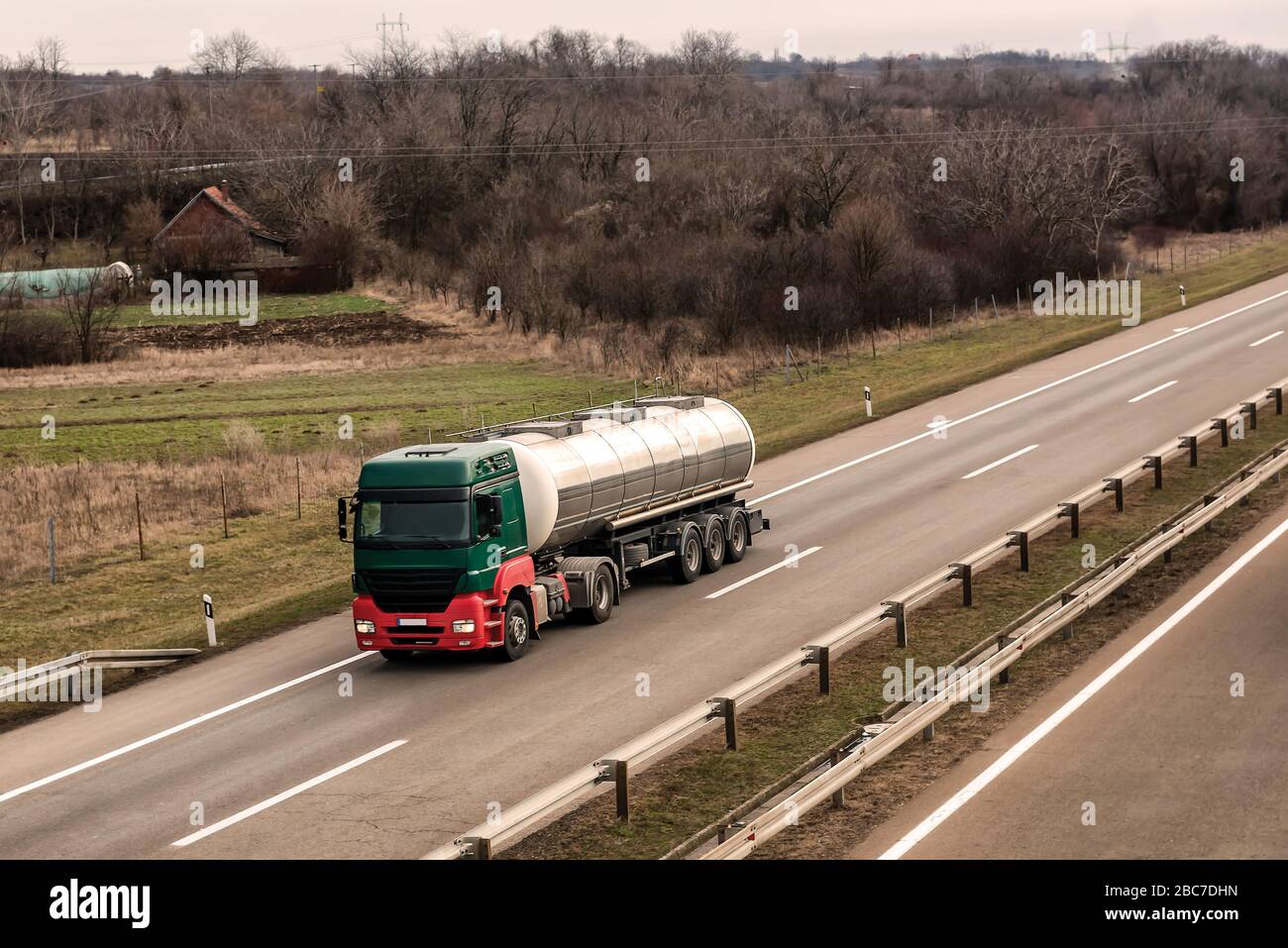 Tank truck on a rural country highway or motorway with light traffic ...