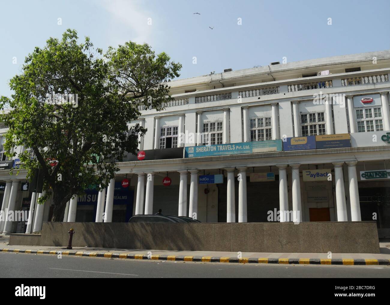 New Delhi, India- March 2018: Streetside view of the facade of shops ...