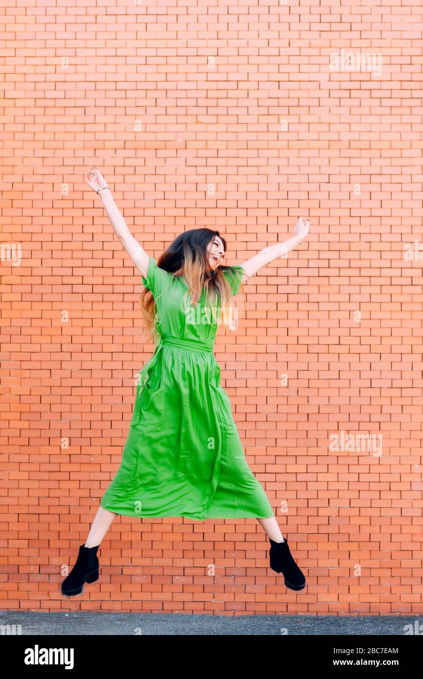 Young woman jumping happily hi-res stock photography and images - Alamy