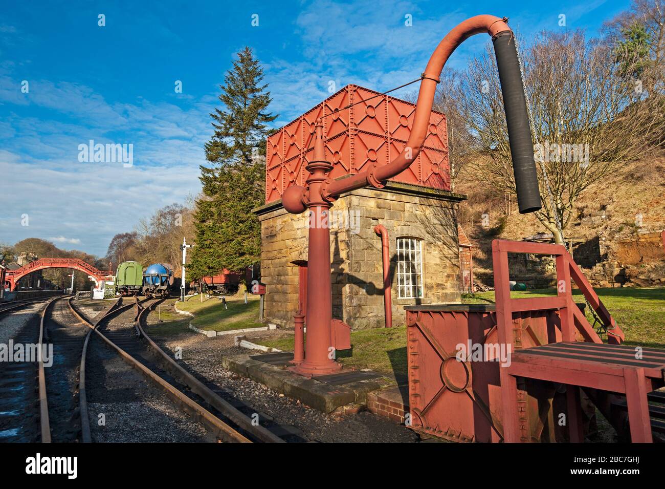 Old traditional railway water steam engine water pump and rolling stock ...