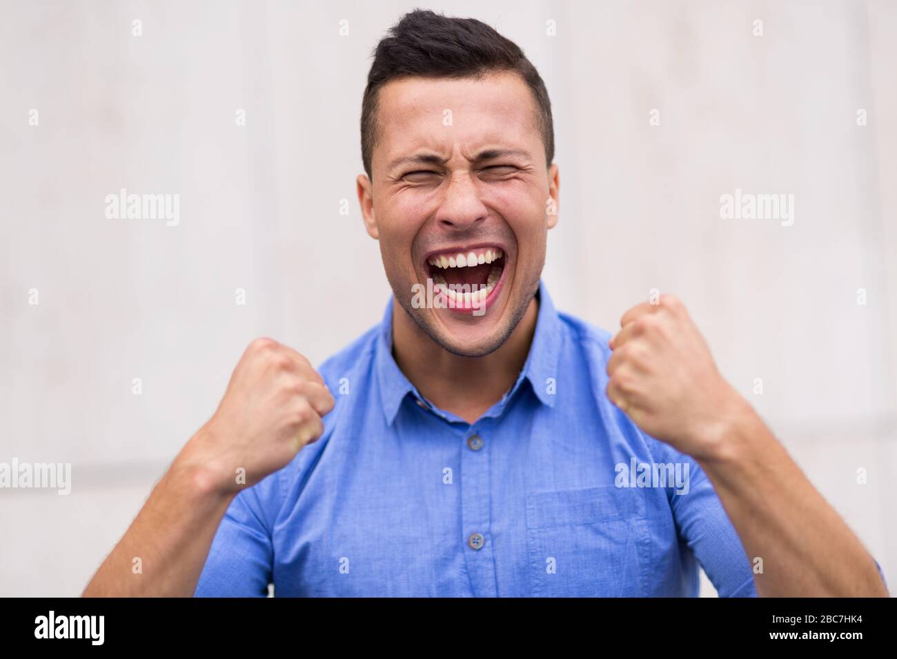 Man clenching fists Stock Photo - Alamy