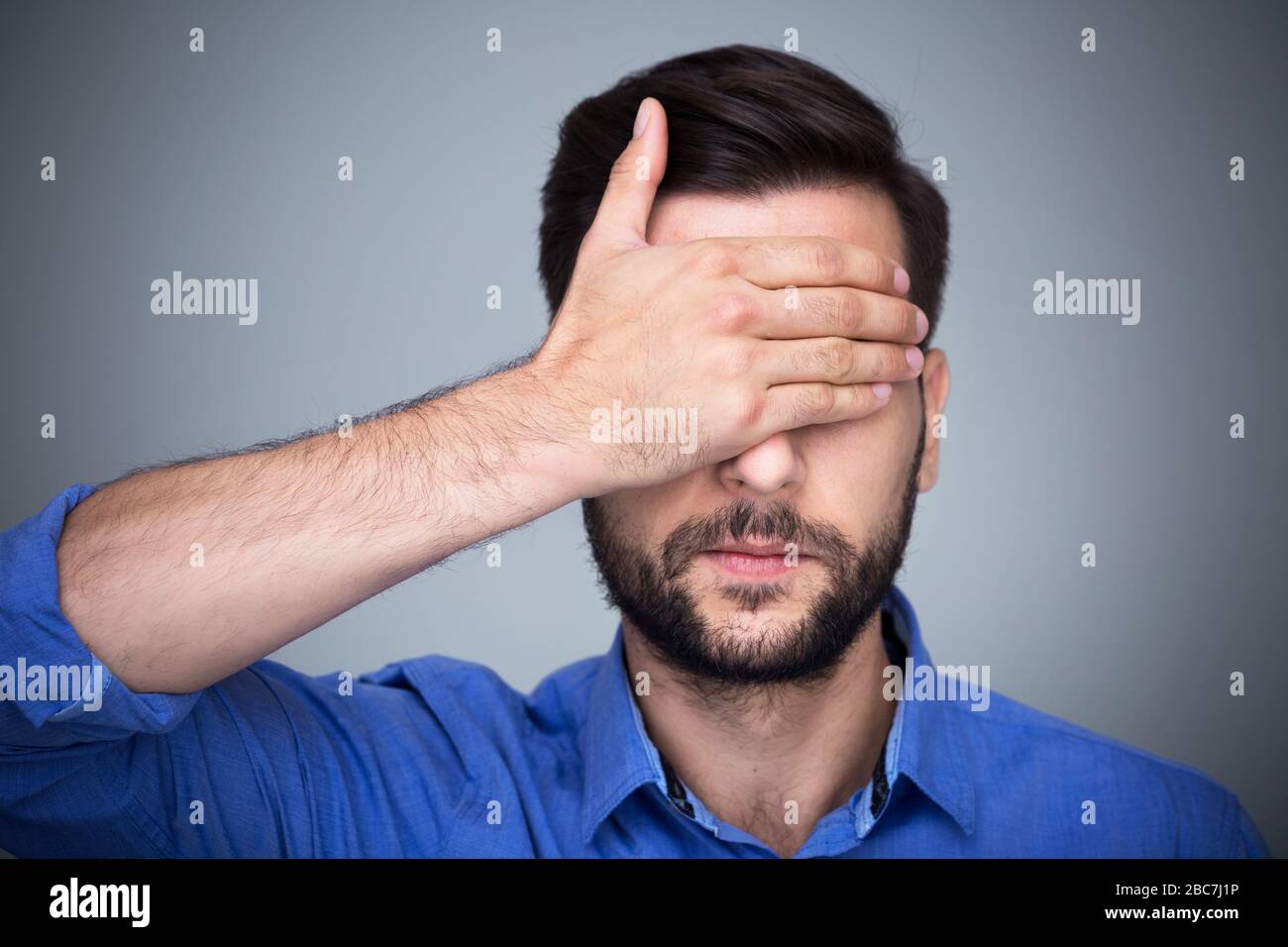 Man covering eyes Stock Photo - Alamy