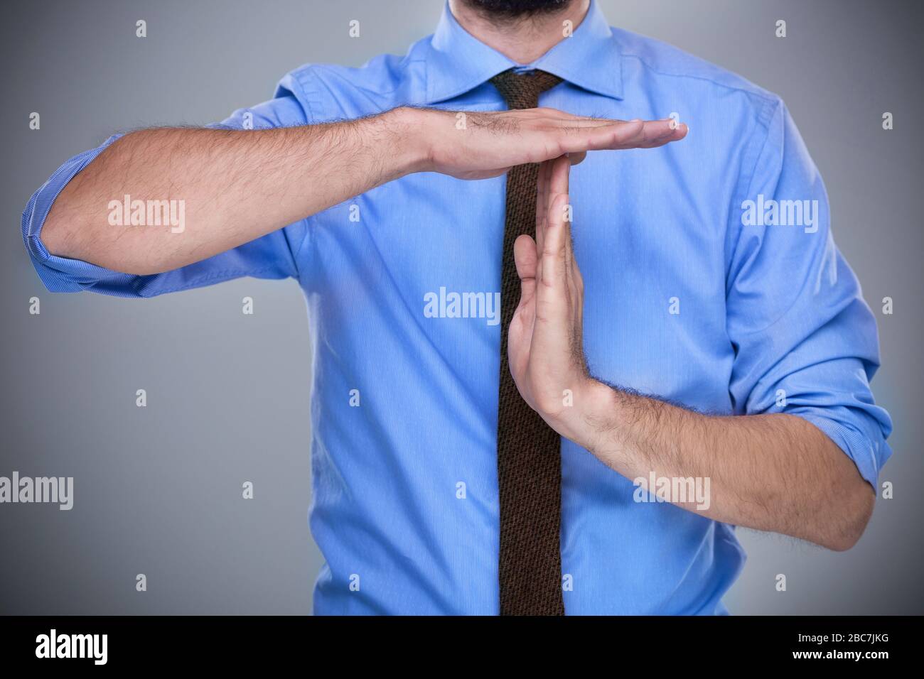 Man showing time out gesture Stock Photo - Alamy