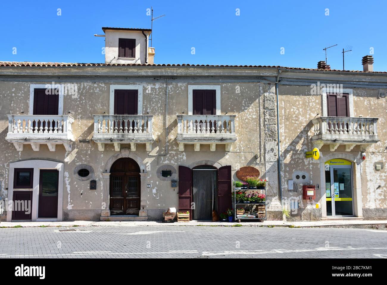 Facade of a house with a flower shop in Castel San Vincenzo, Italy ...