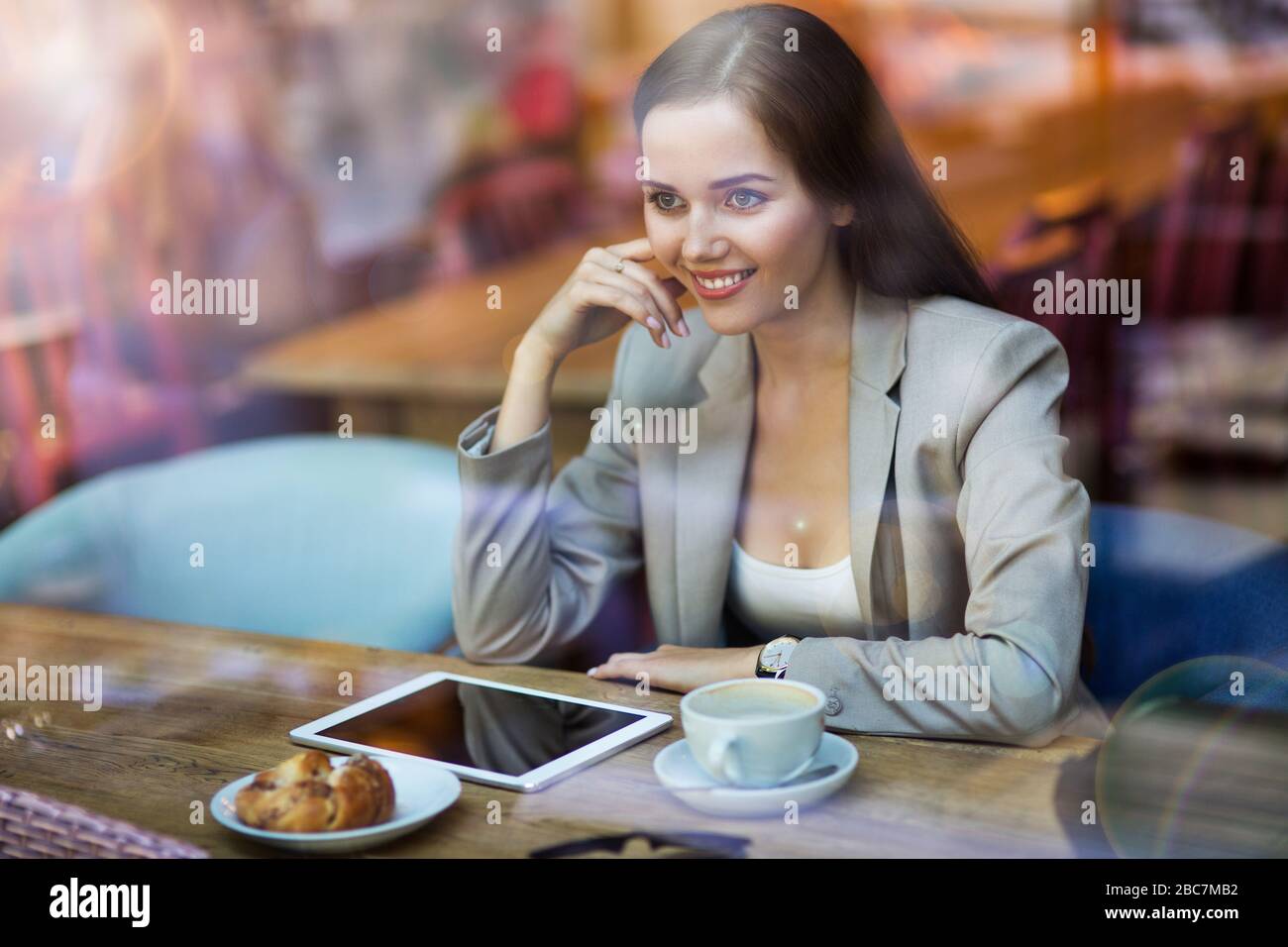 Young woman sitting coffee shop hi-res stock photography and images - Alamy
