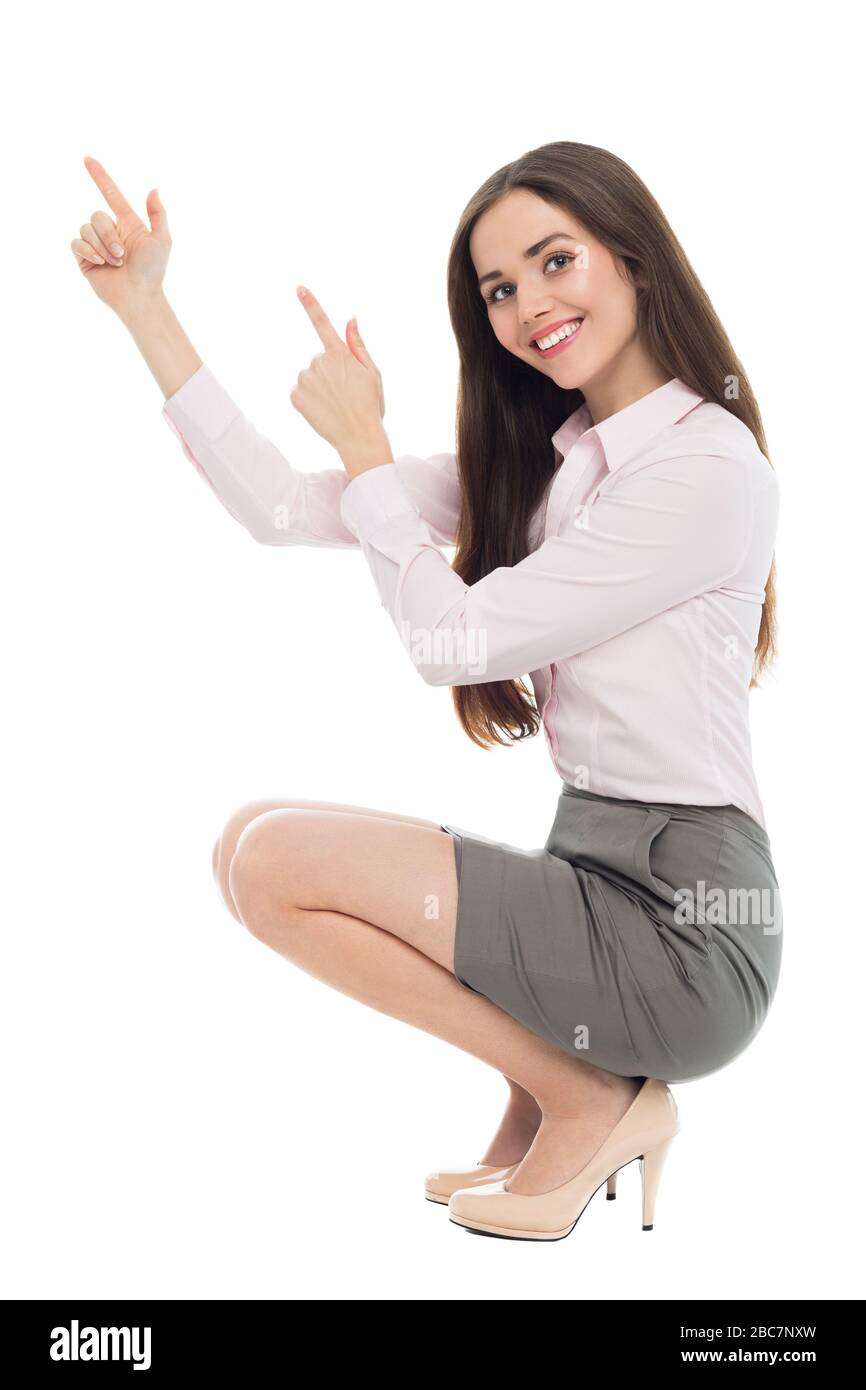 Woman crouching and pointing fingers Stock Photo - Alamy