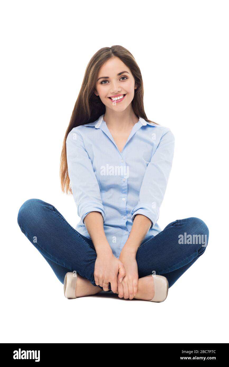 Young woman sitting on white background Stock Photo - Alamy
