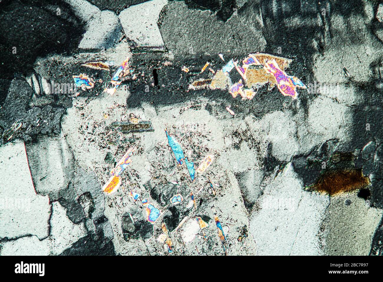 Granite rock under the microscope 100x Stock Photo - Alamy