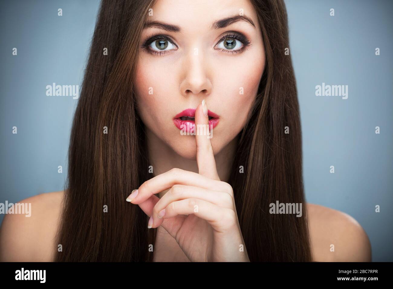 Woman gesturing silence finger on hi-res stock photography and images ...