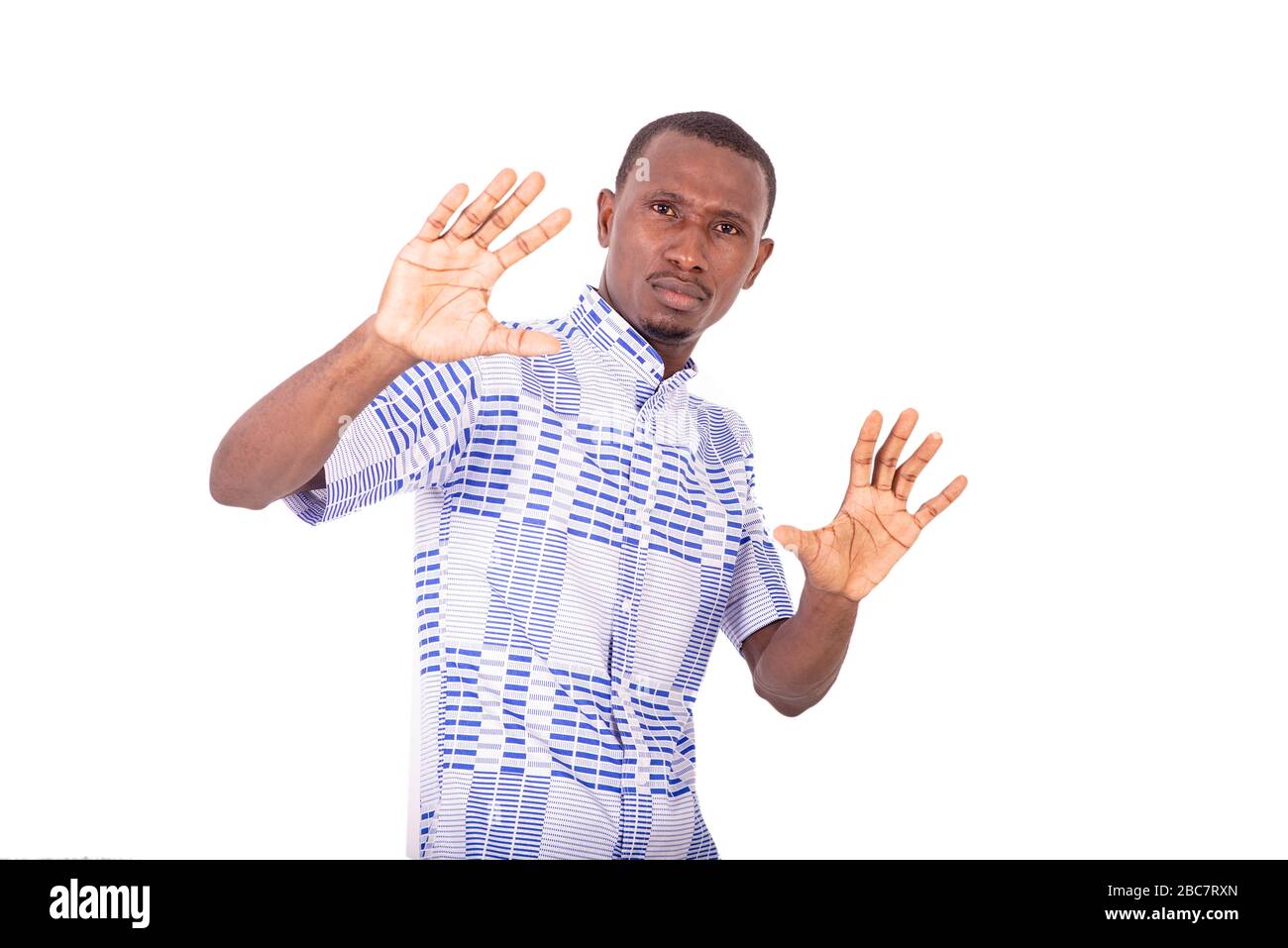 a young man in a shirt standing on a white background showing the ...