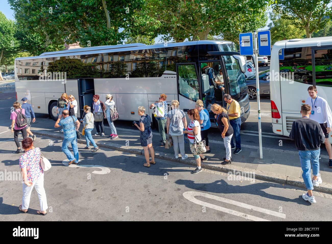 Bus-stop with travellers leaving a coach downtown Luxembourg city Stock ...