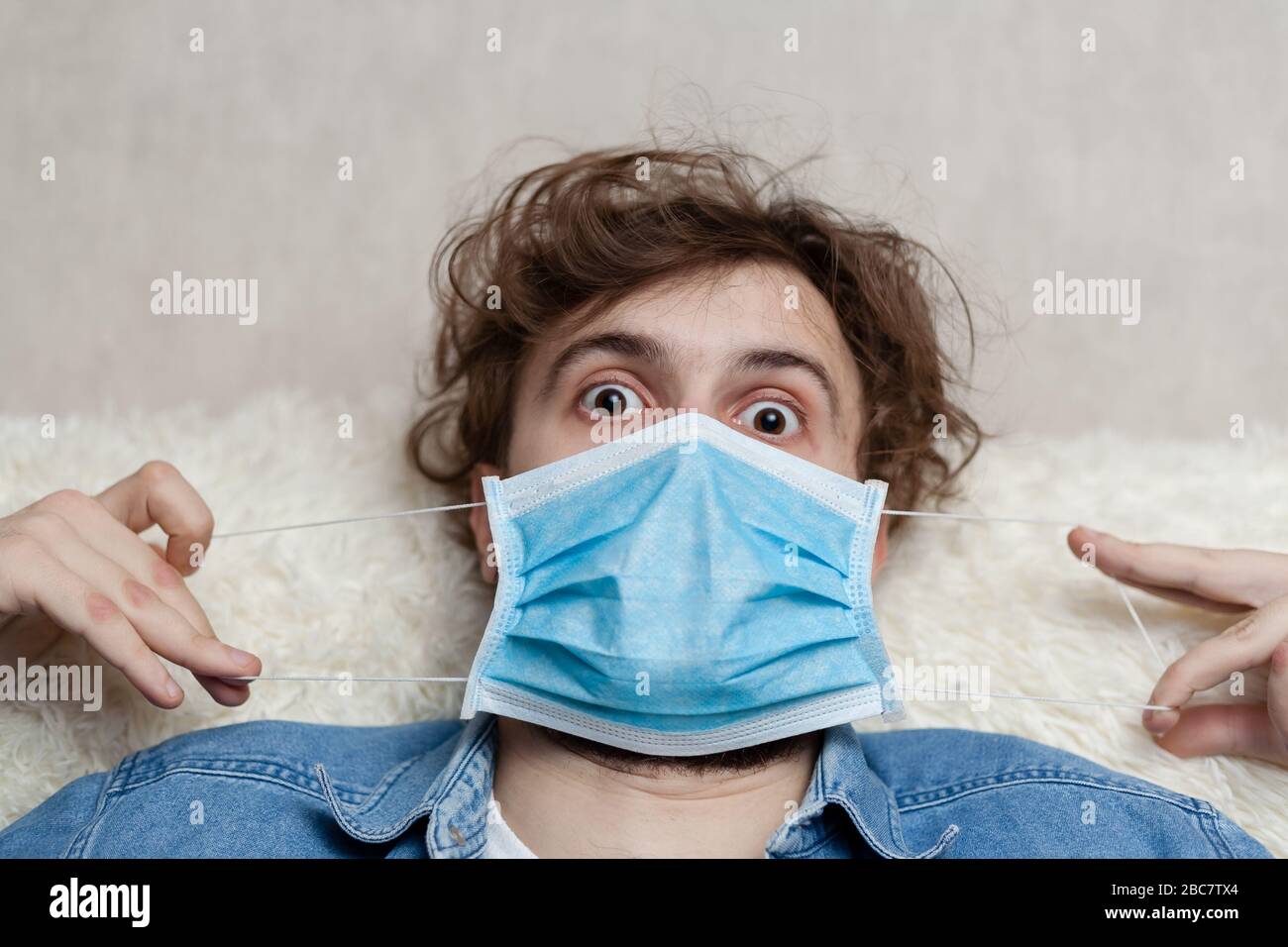 Portrait of a guy with a medical mask that stinks. Bad smell of a ...