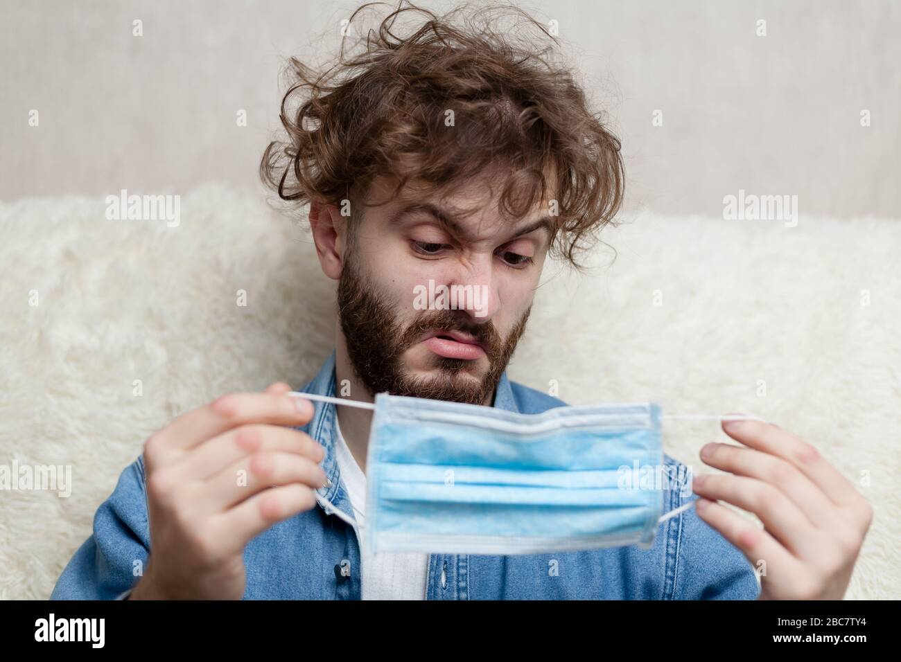Portrait of a guy with a medical mask that stinks. Bad smell of a ...