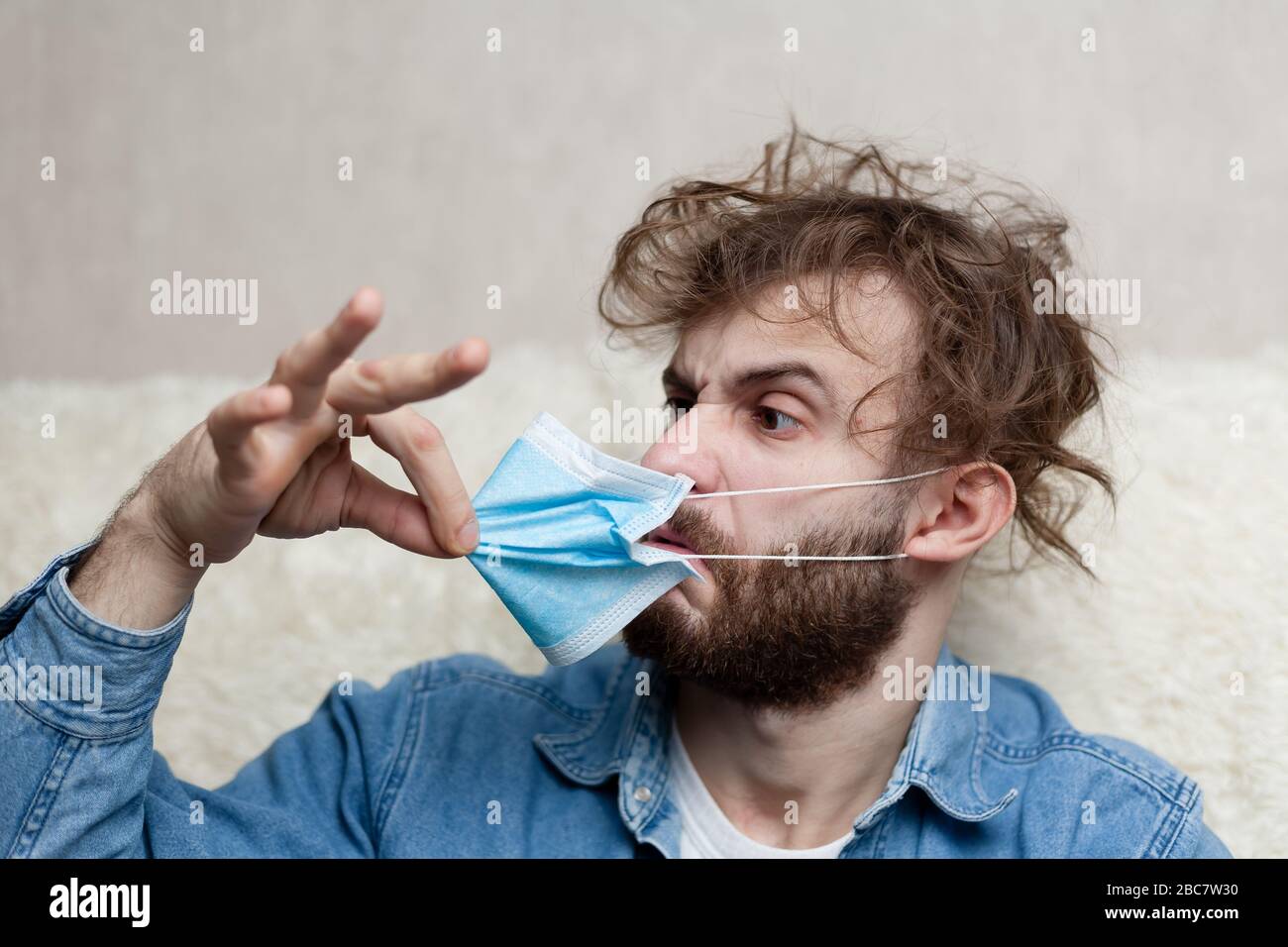 Portrait of a guy with a medical mask that stinks. Bad smell of a ...