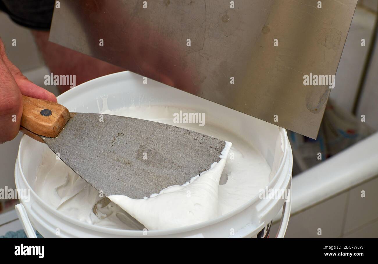 Finishing trowel and spatula with white spackling compound Stock Photo ...