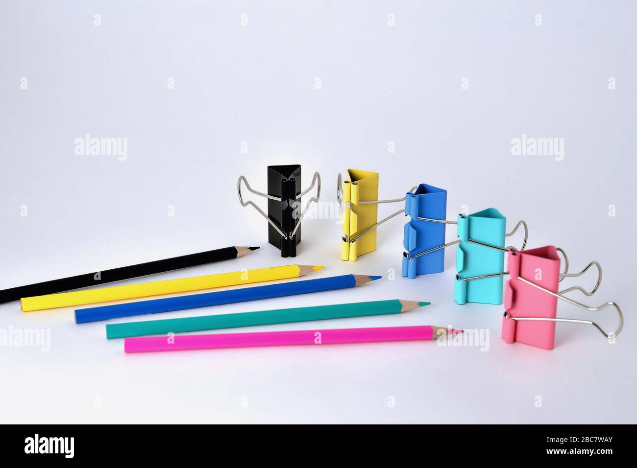 Pencils and clamps on white background Stock Photo - Alamy