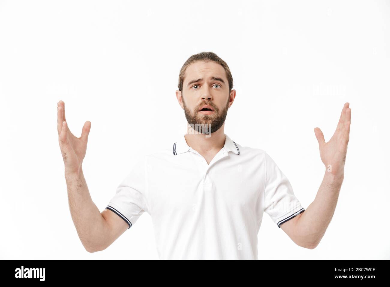 Photo of confused displeased shocked young handsome bearded man posing ...