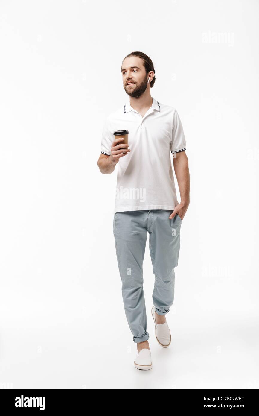 Photo of a young positive happy handsome bearded man walking isolated ...