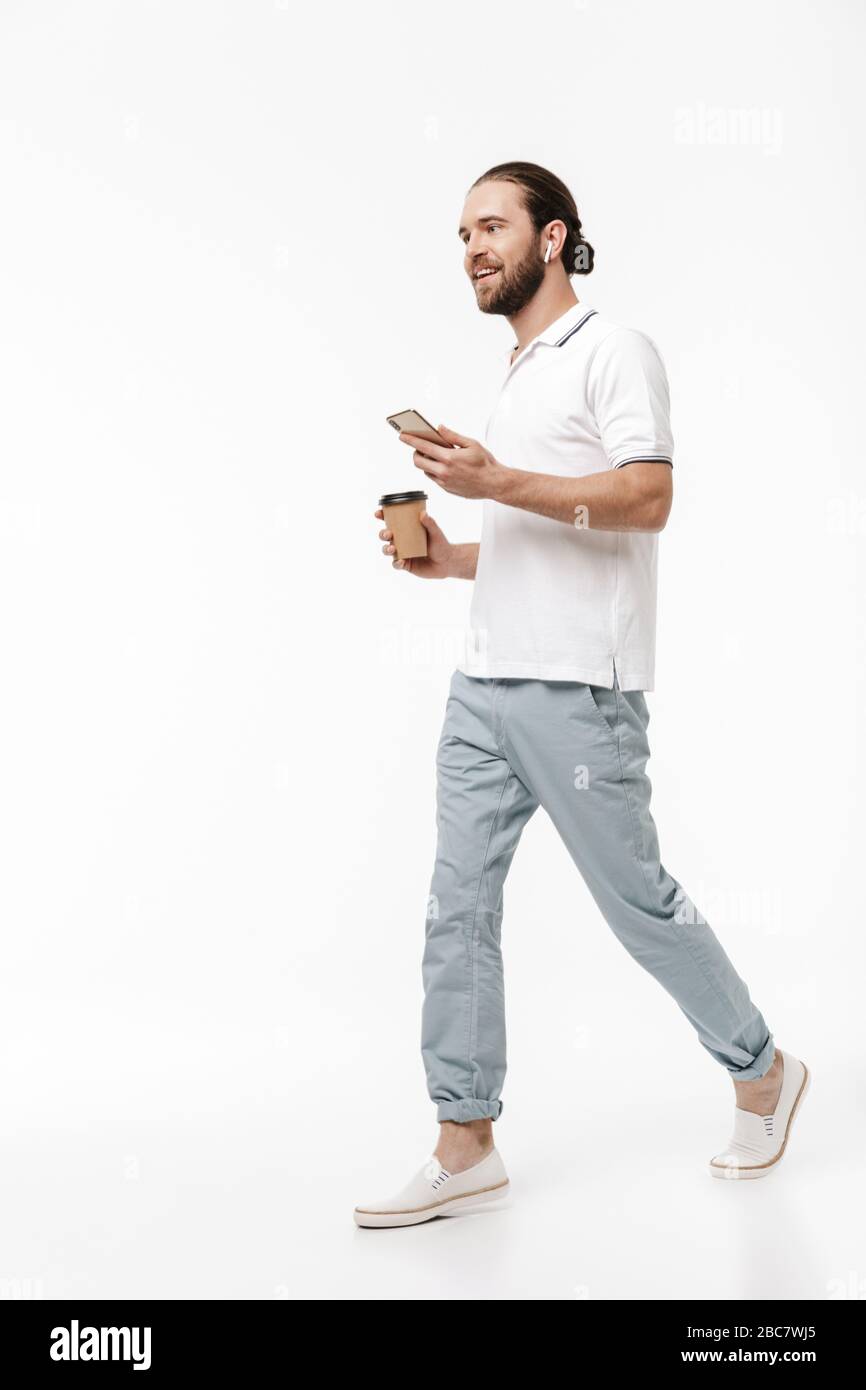 Photo of a young positive happy handsome bearded man walking isolated ...