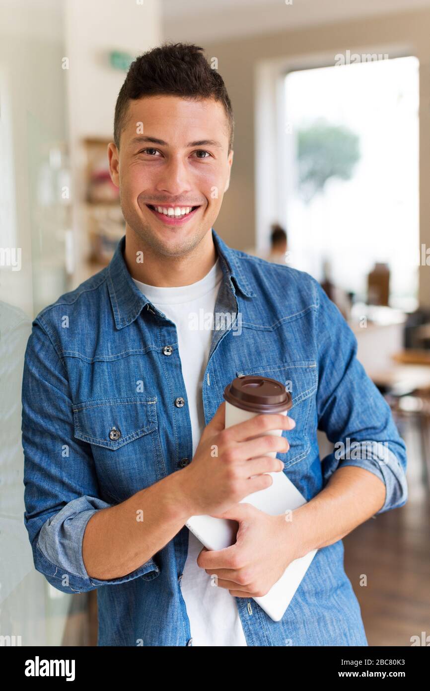 Young man in cafe Stock Photo - Alamy