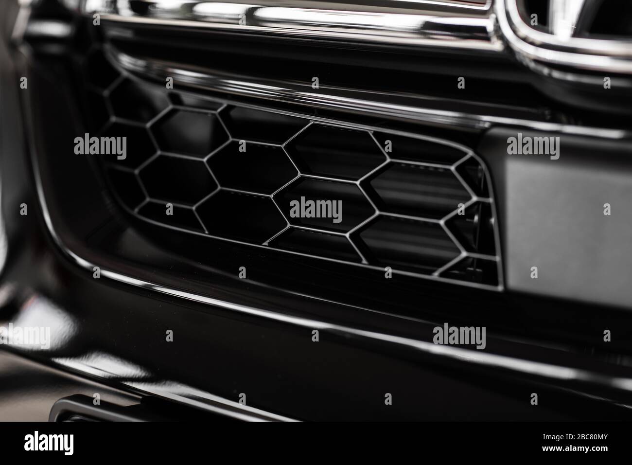 Grid of white sports car. The radiator grille. Metal texture. chrome ...