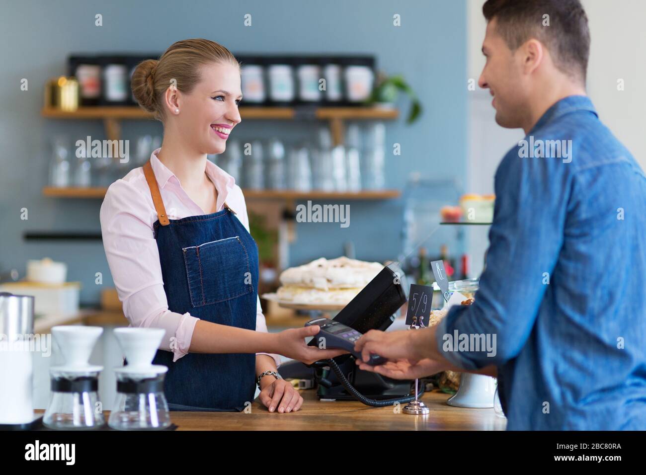 Serving customer at the coffee shop Stock Photo - Alamy