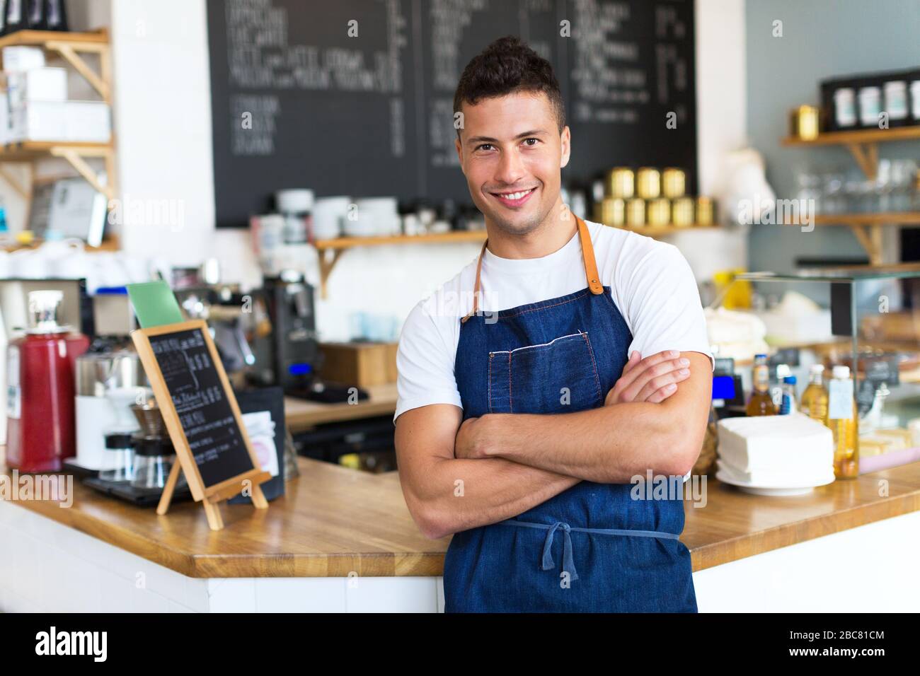 Proud young cafe owner Stock Photo - Alamy