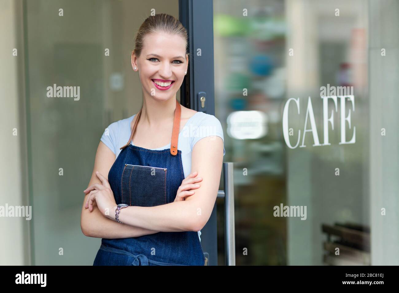 Proud young female cafe owner Stock Photo - Alamy